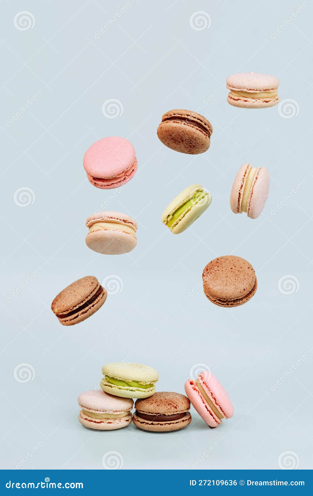 Lots of Macarons Falling Down Isolated on Blue Background. Stock Photo ...