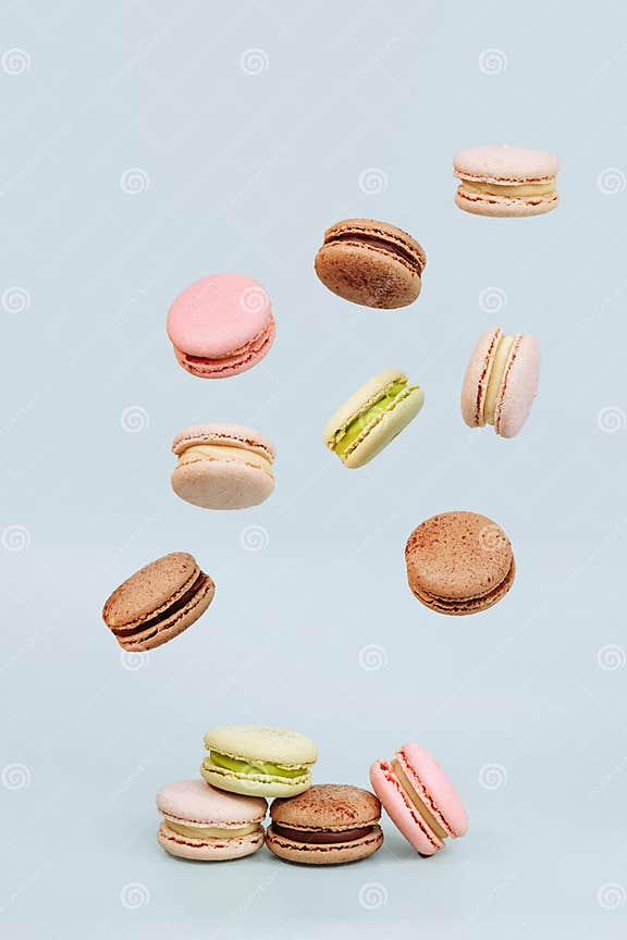 Lots of Macarons Falling Down Isolated on Blue Background. Stock Photo ...