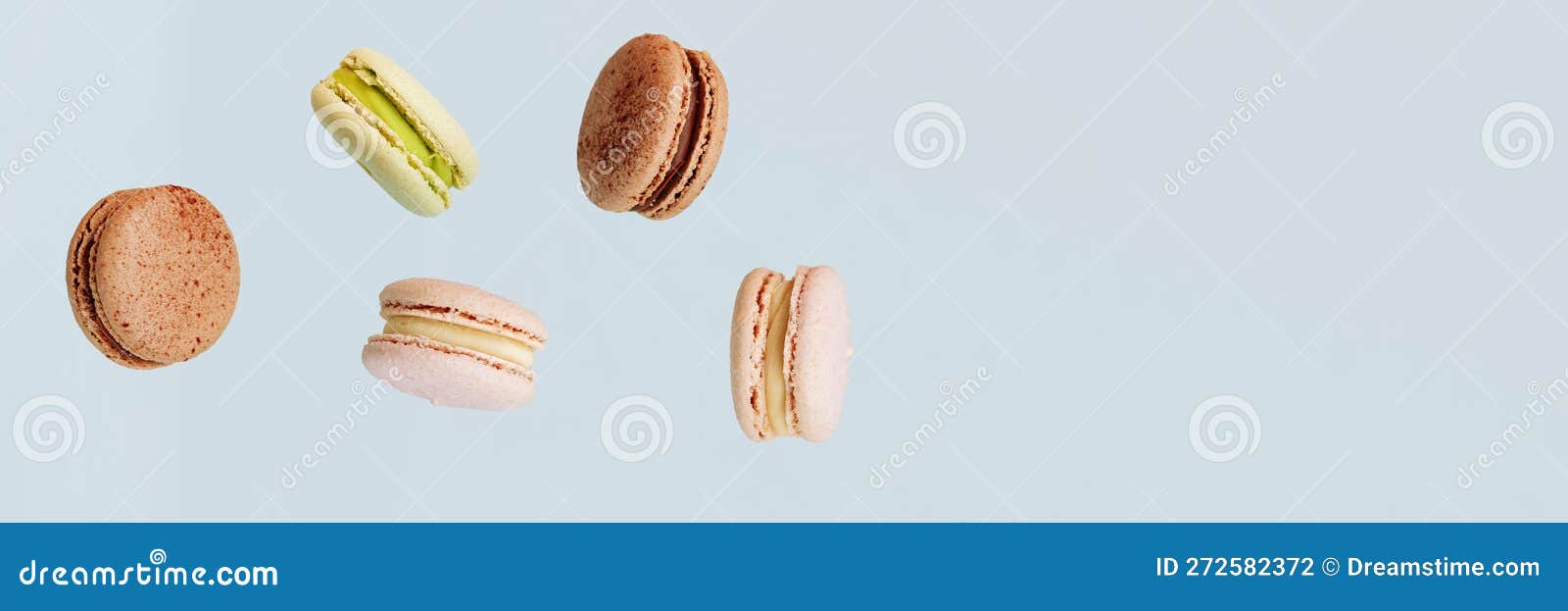 Lots of Macarons Falling Down Isolated on Blue Background. Stock Photo ...