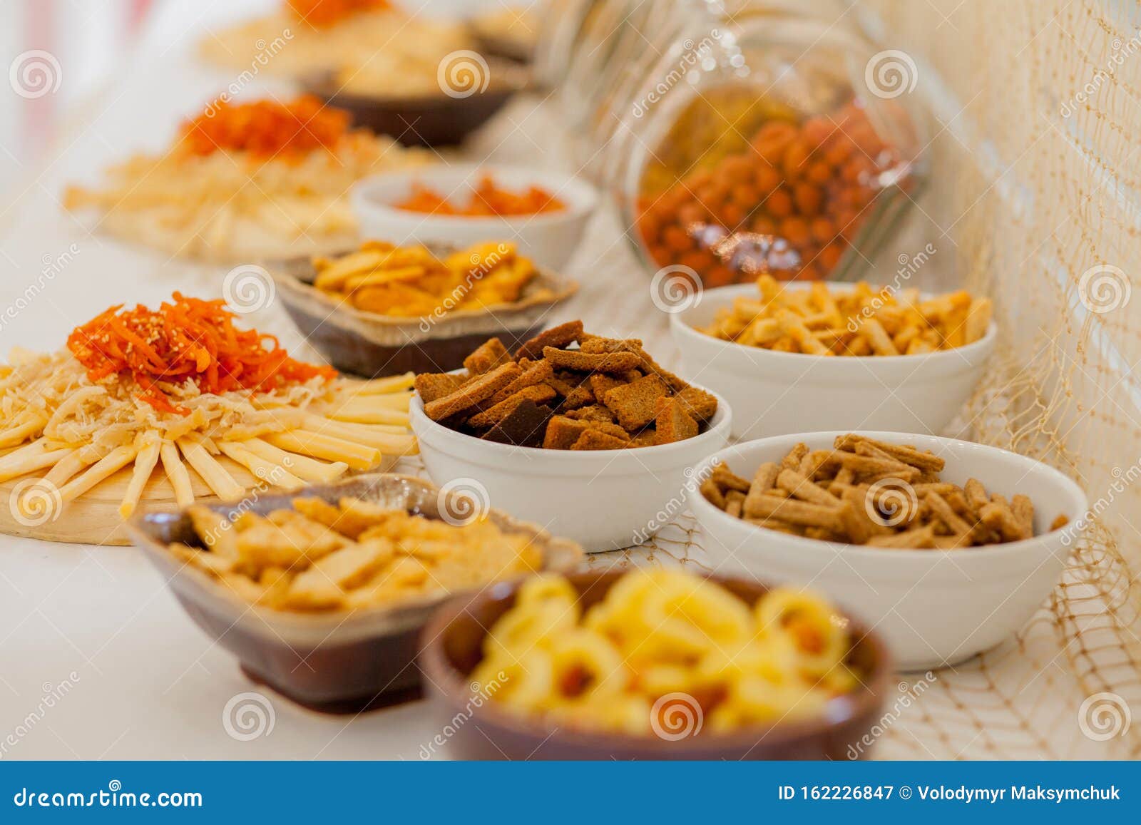 A Lots of Salty Snacks on a Table, Many Cheese and Crackers on the ...