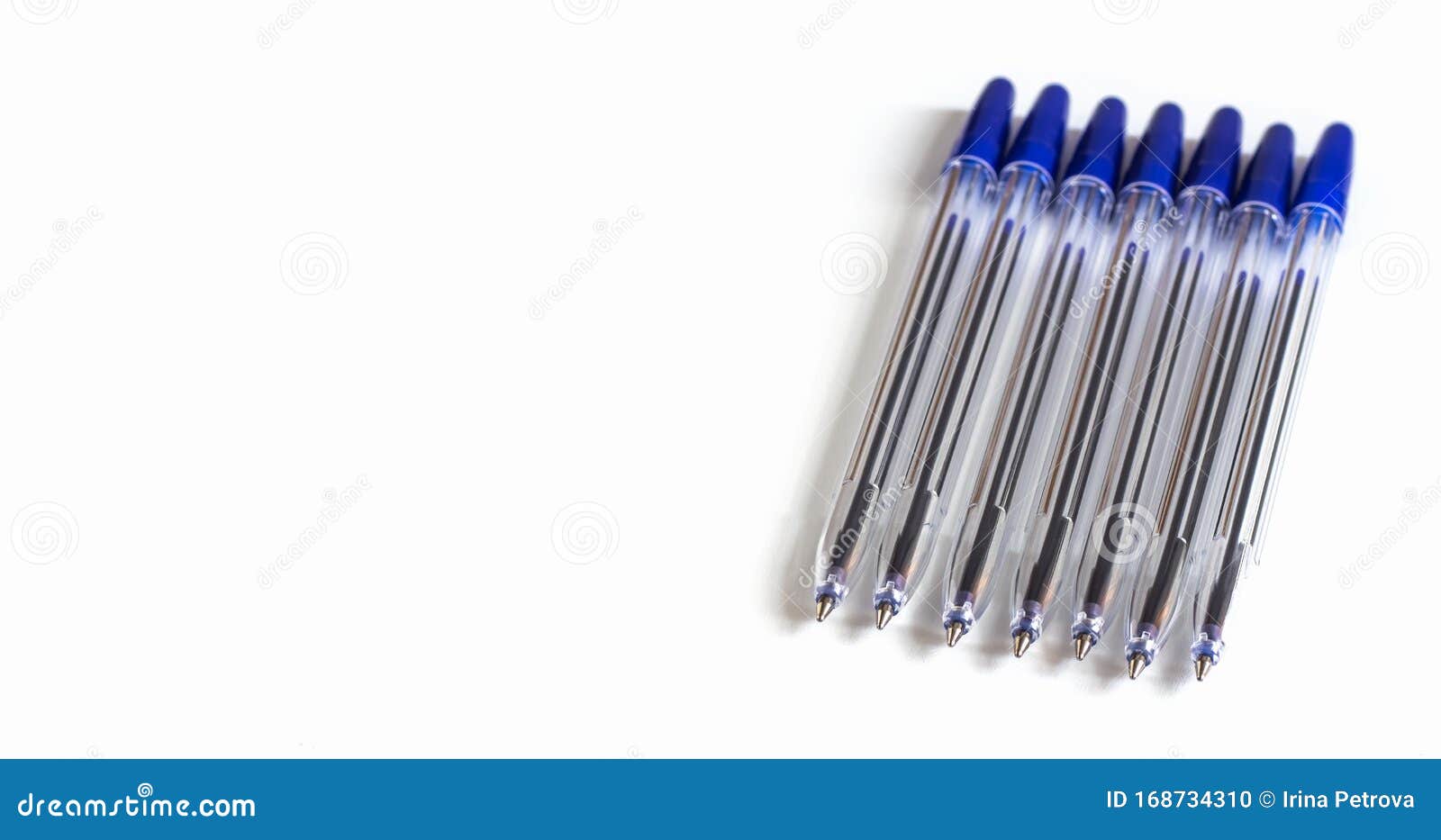 Lots of Transparent Ballpoint Pens with a Blue Cap on a White ...
