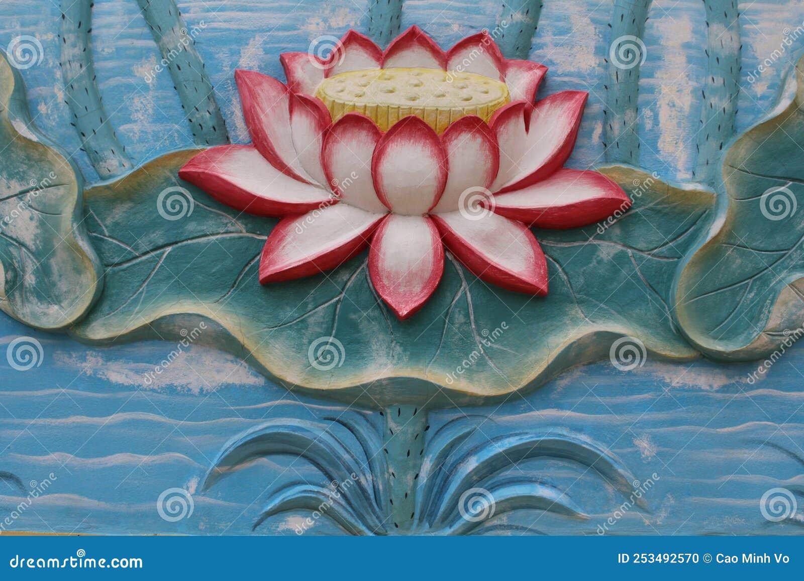 A lotus statue on the wall stock photo. Image of statue - 253492570