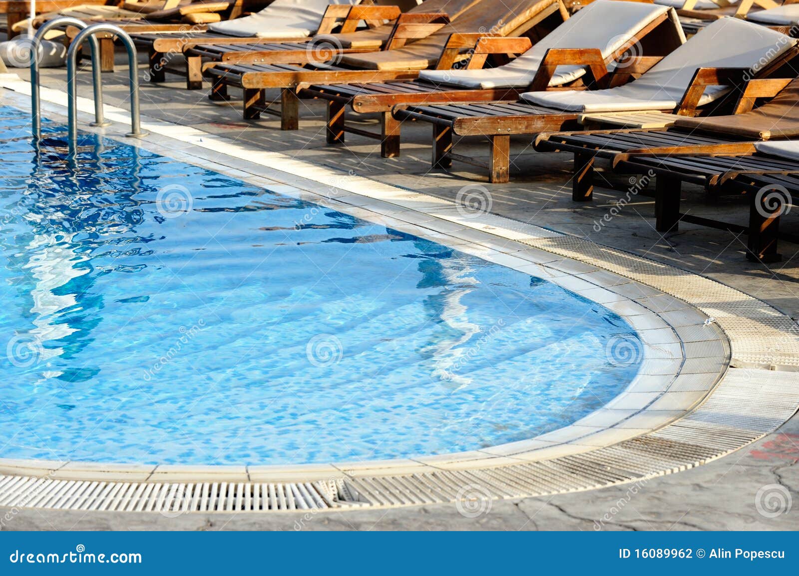 Lounge chairs and pool stock photo. Image of morning - 16089962