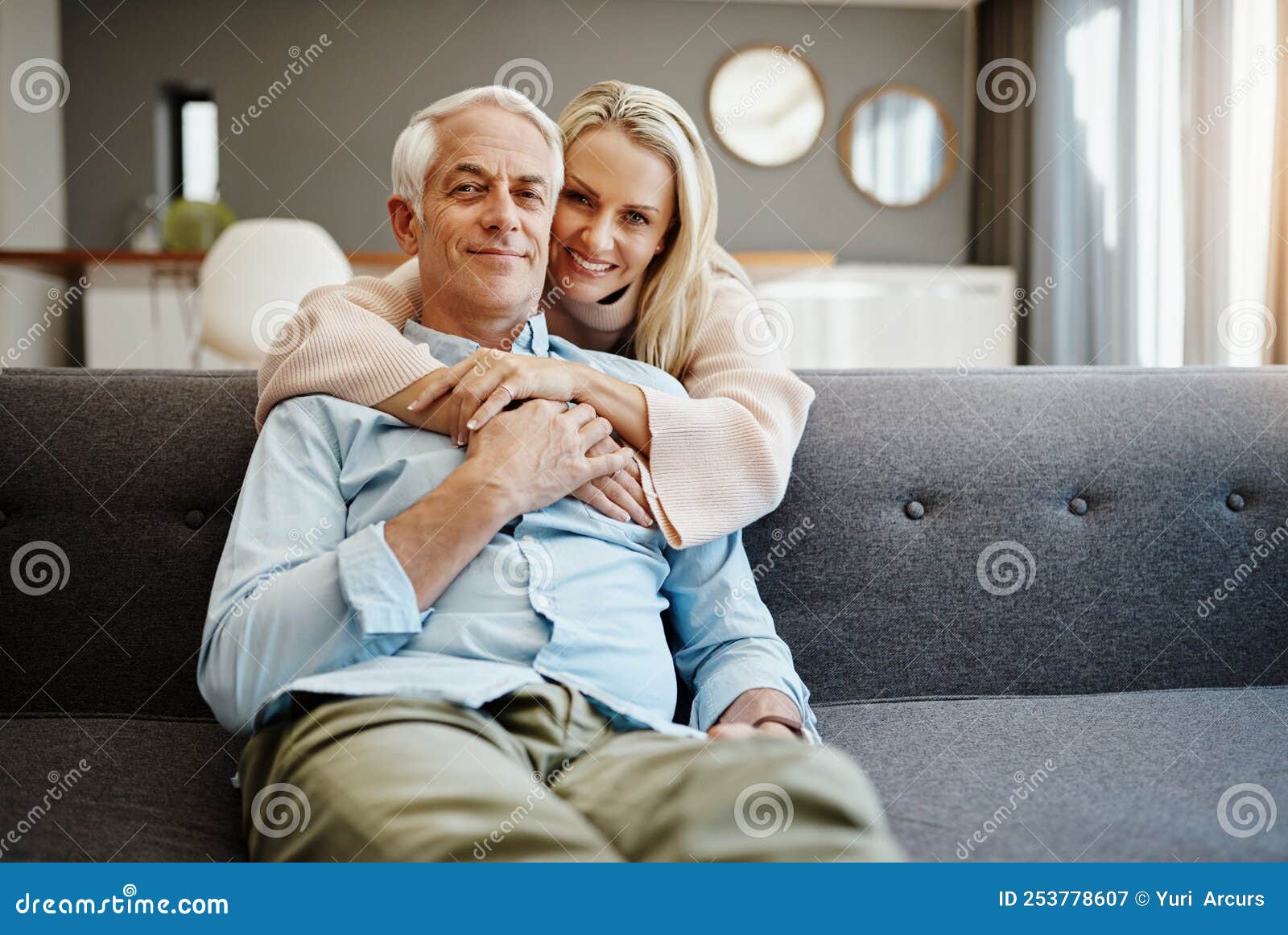 Love Each Other A Lot A Mature Woman Hugging Her Husband On The Sofa