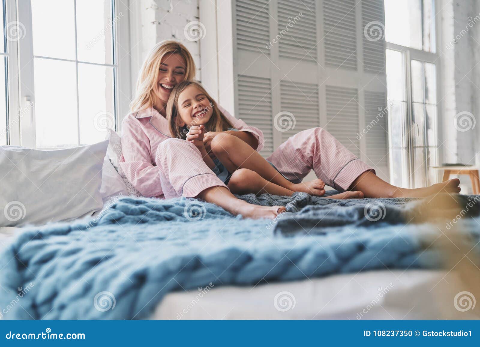 Love And Joy Beautiful Young Mother Embracing Her Daughter And Stock