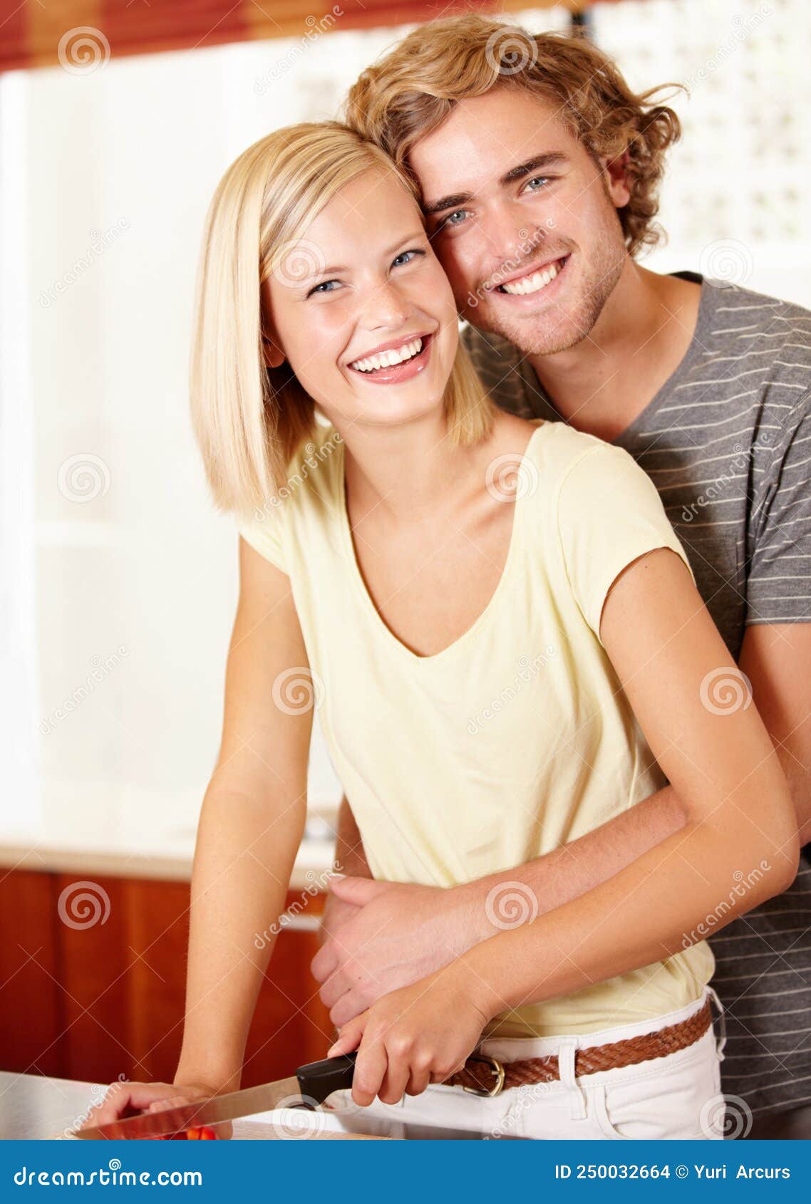 Love in the Kitchen. Portrait of a Young Couple Standing in the Kitchen ...