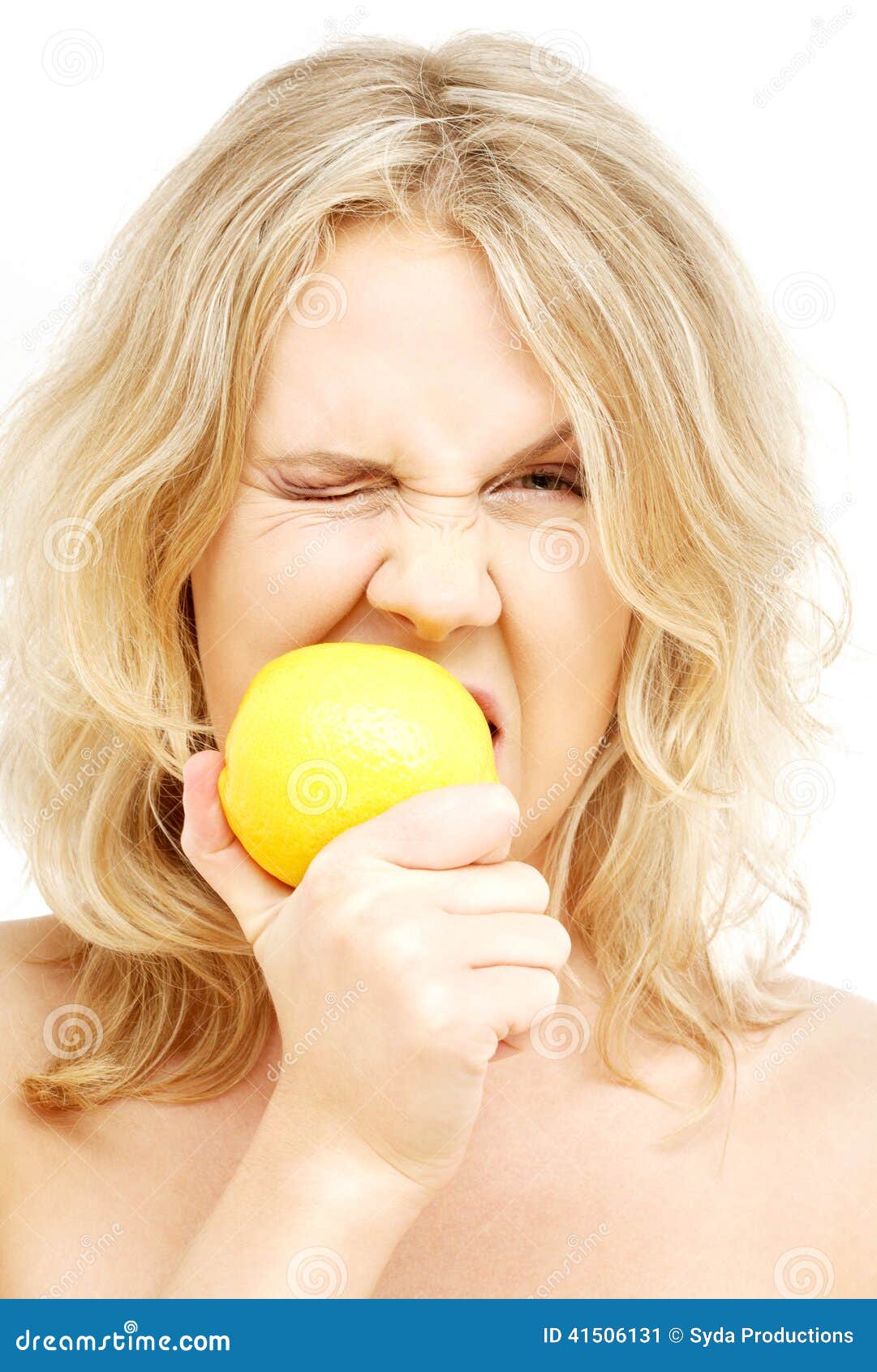 Lovely blond biting lemon stock image. Image of citrus - 41506131