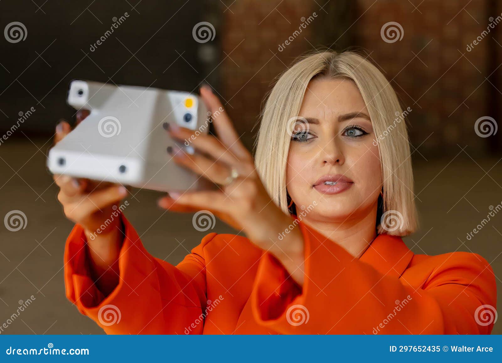 A Lovely Blonde Model Poses Outdoors Using Her Camera while Enjoying ...