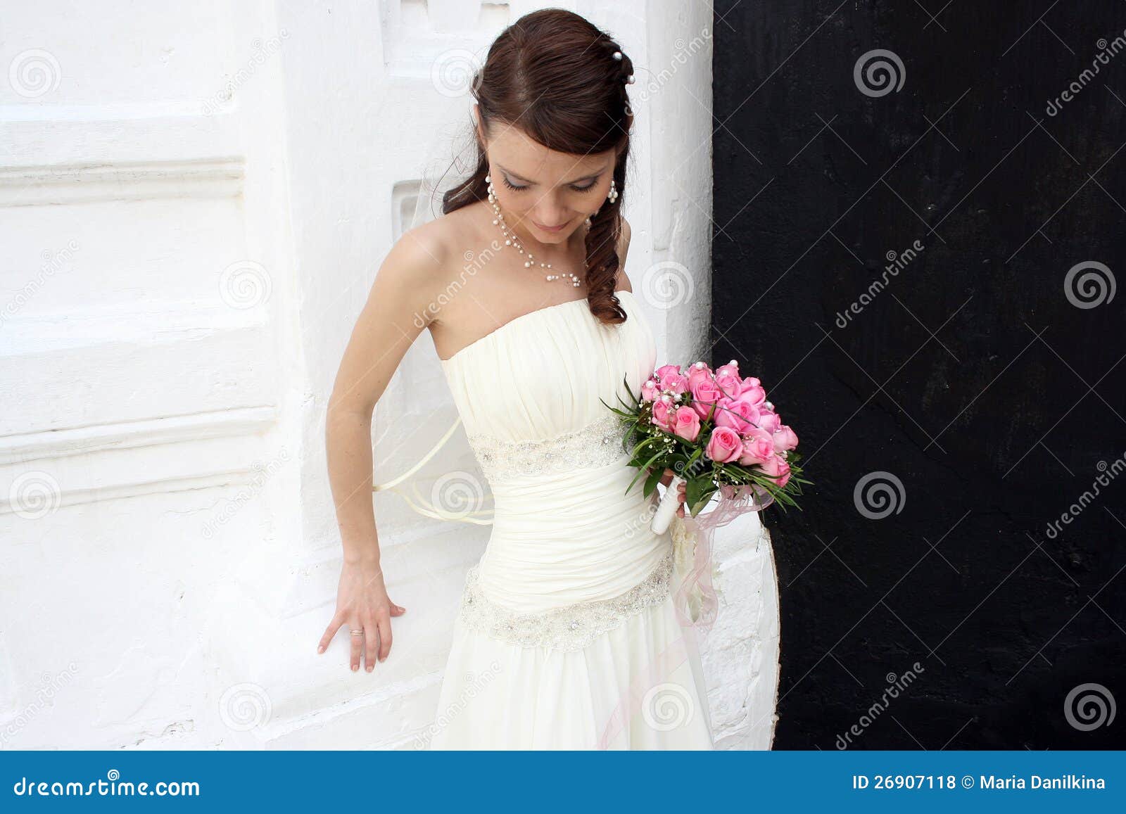 A lovely bride looks down stock photo. Image of holding - 26907118