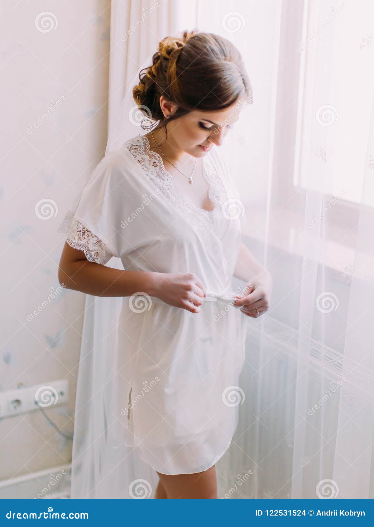 The Lovely Bride in the Silk Robe Standing Near the Window. Stock Photo ...