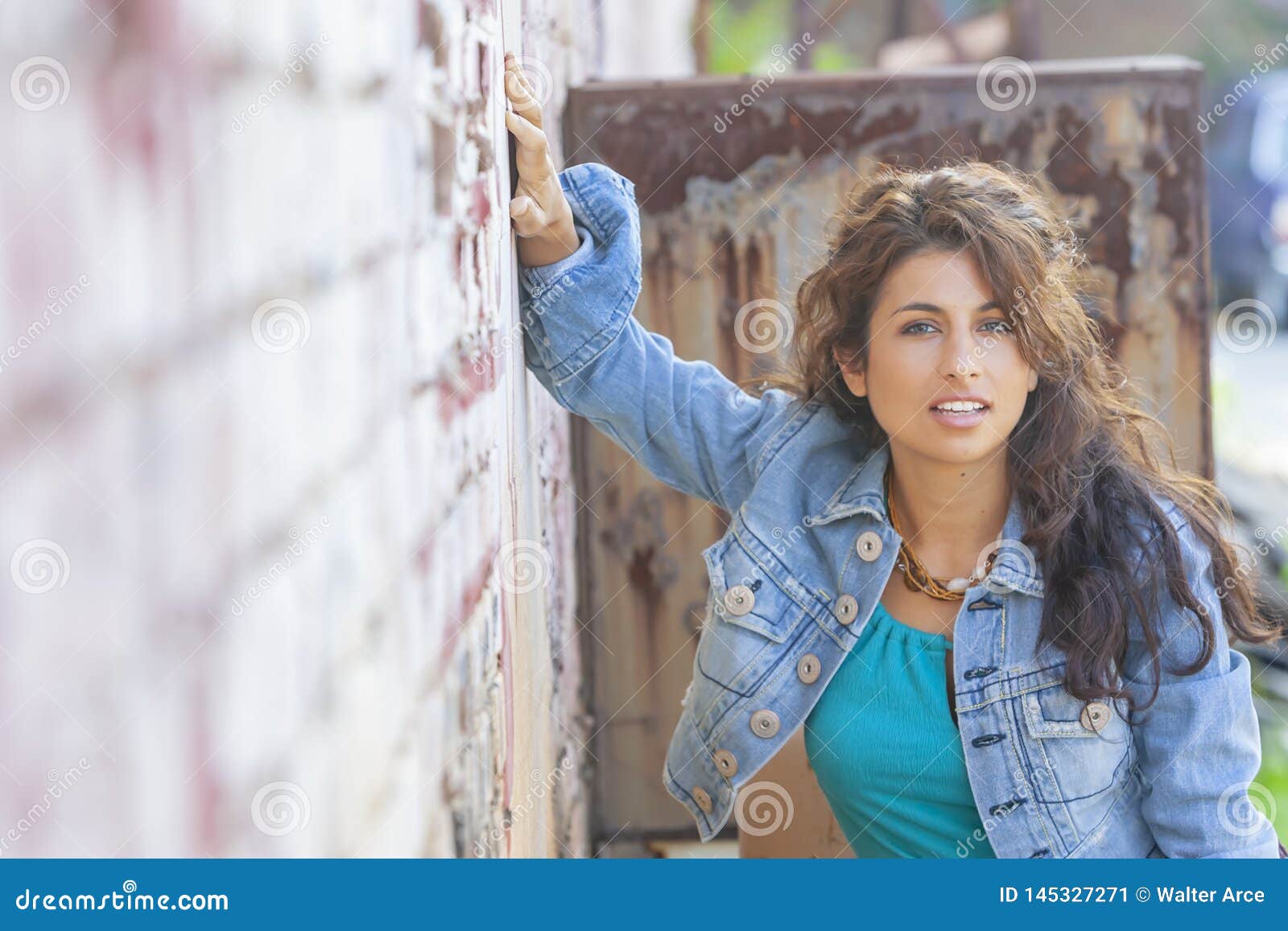 A Lovely Brunette Model Posing Outdoors With The Latest Fashions Stock