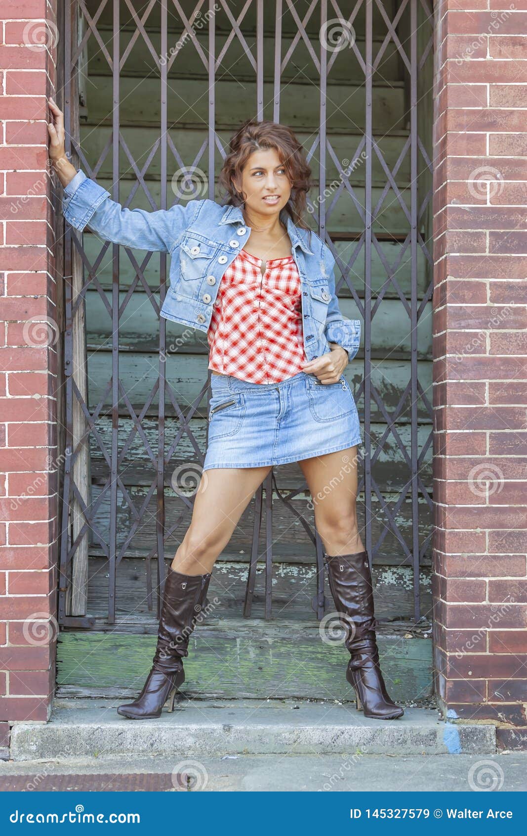 A Lovely Brunette Model Posing Outdoors With The Latest Fashions Stock