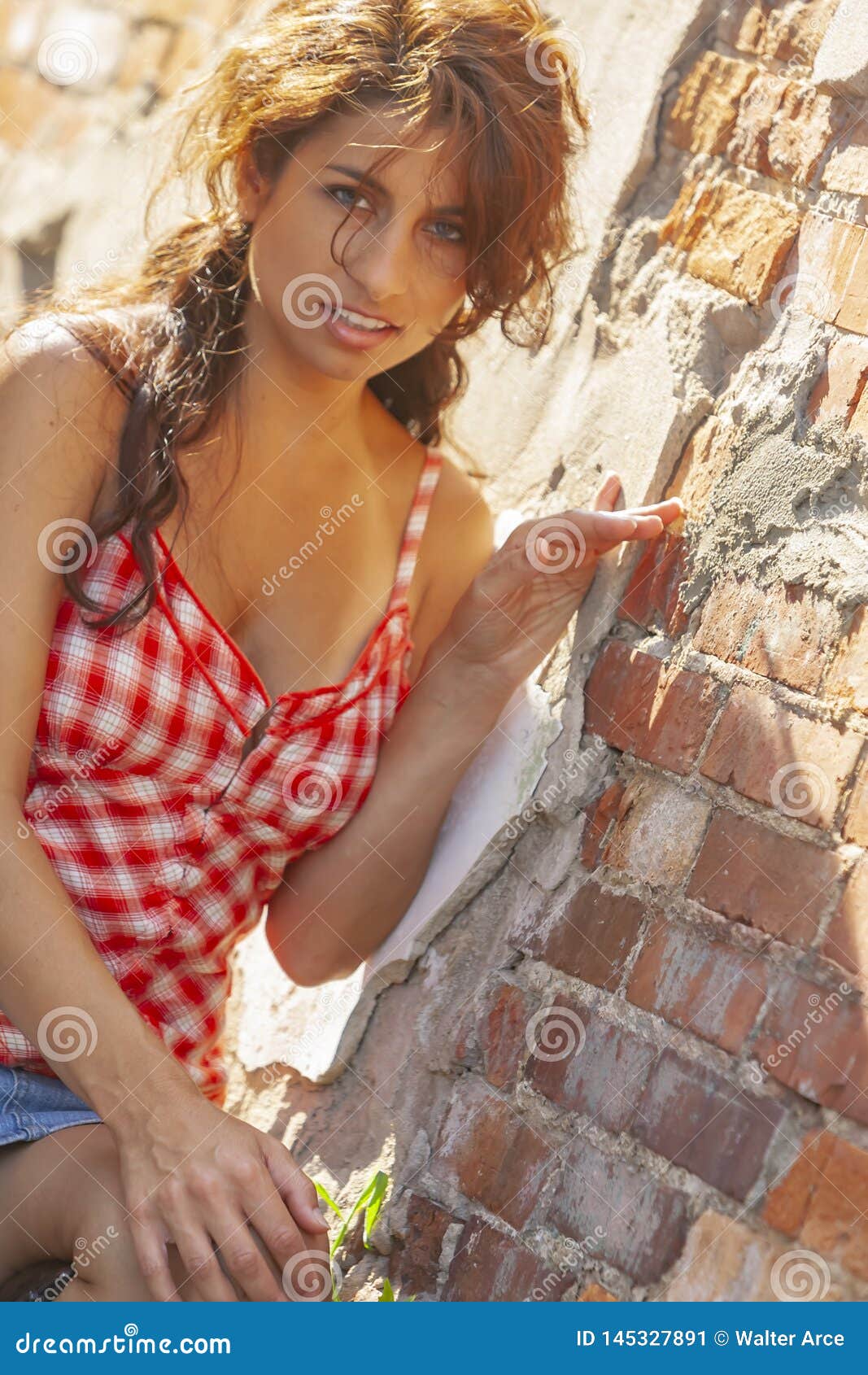 A Lovely Brunette Model Posing Outdoors With The Latest Fashions Stock
