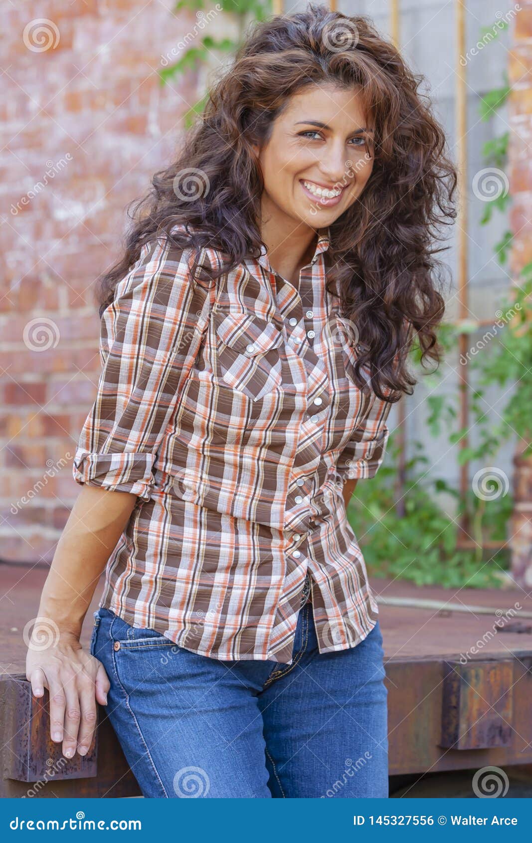 A Lovely Brunette Model Posing Outdoors With The Latest Fashions Stock