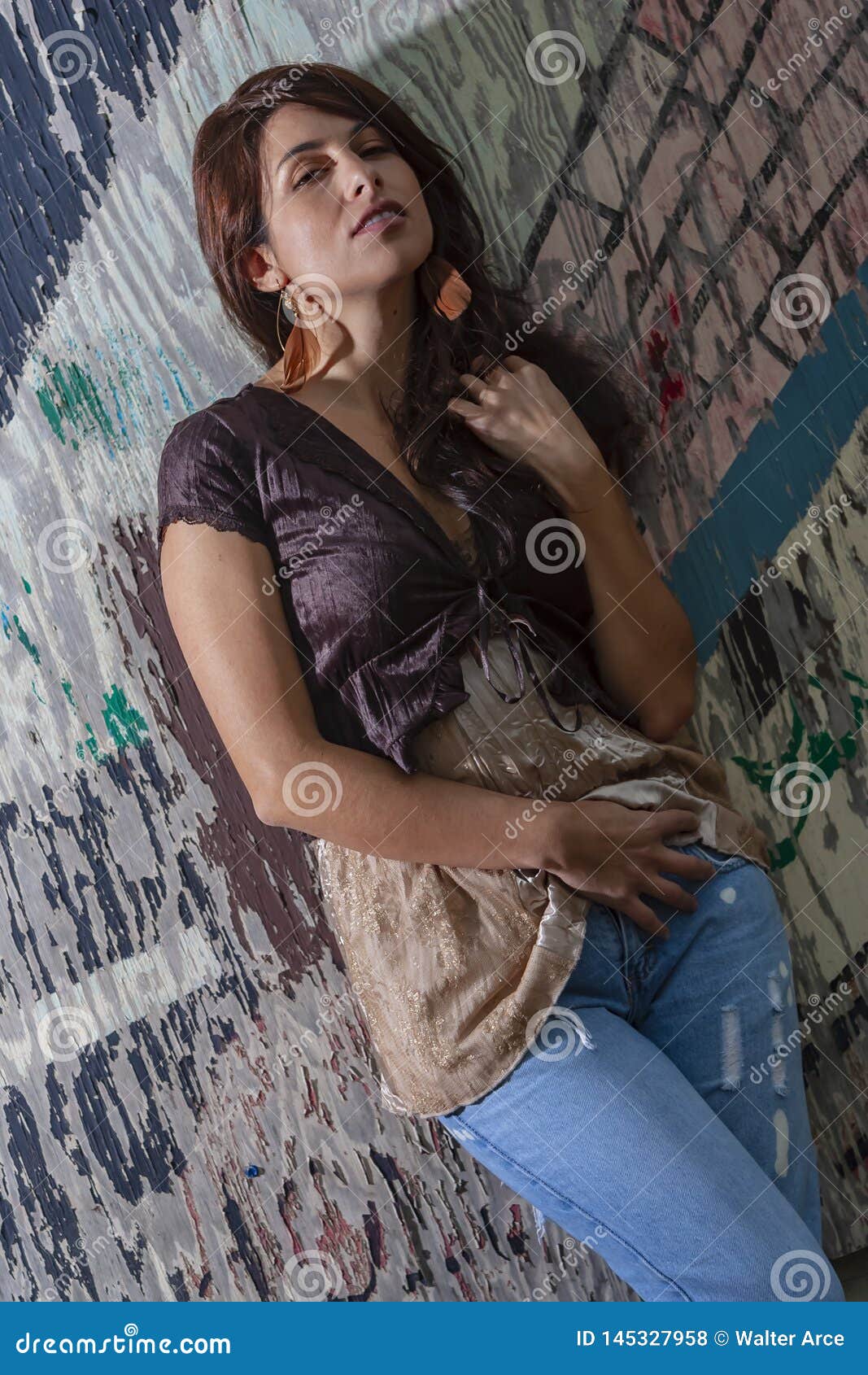 A Lovely Brunette Model Posing Outdoors With The Latest Fashions Stock