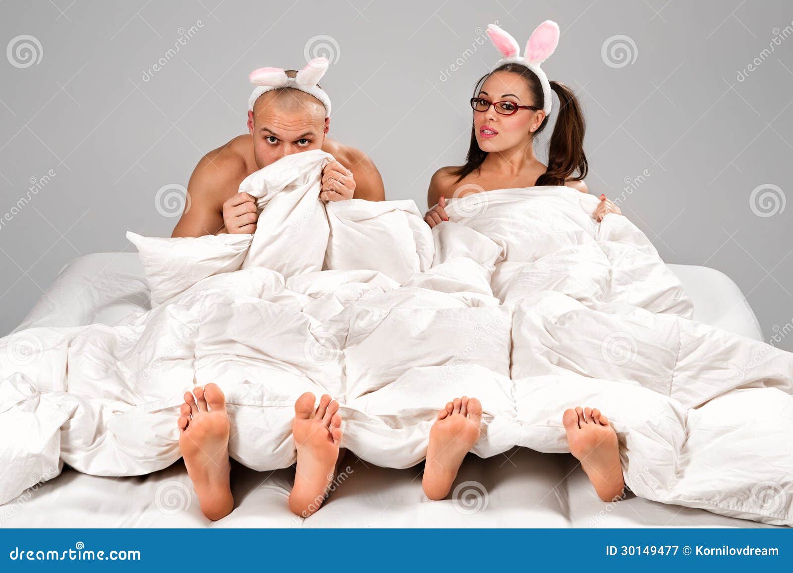 Couple Of Rabbits And Their Young Easter Bunnies Resting In A Garden ...