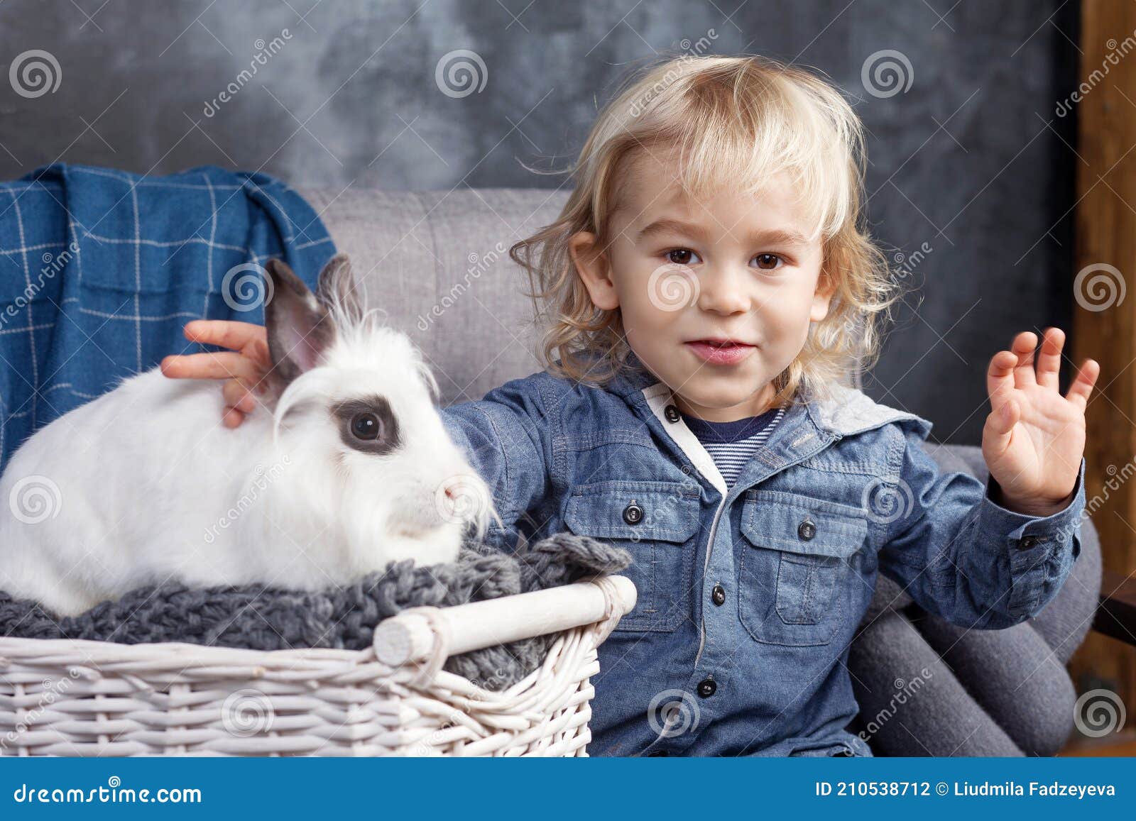 Lovely Little Boy Plays with a White Rabbit. the Boy Smiliing and ...
