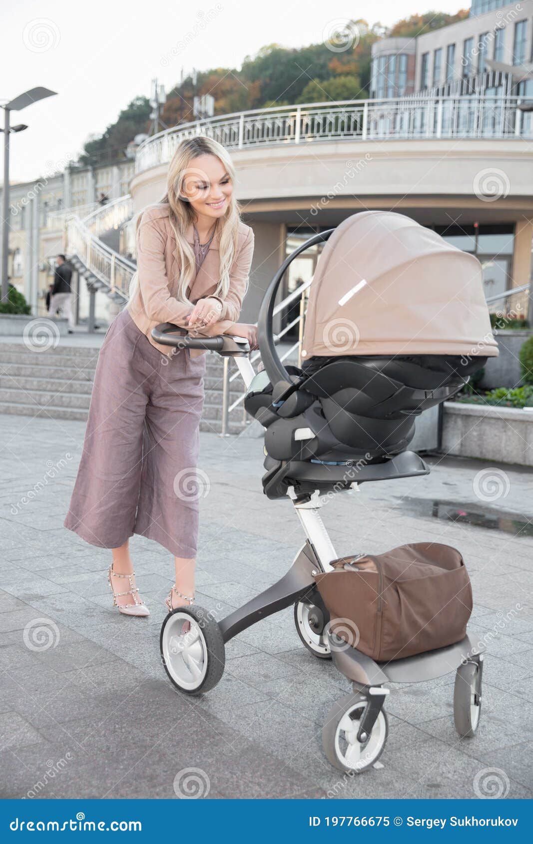 Lovely mother with a pram stock image. Image of gorgeous - 197766675