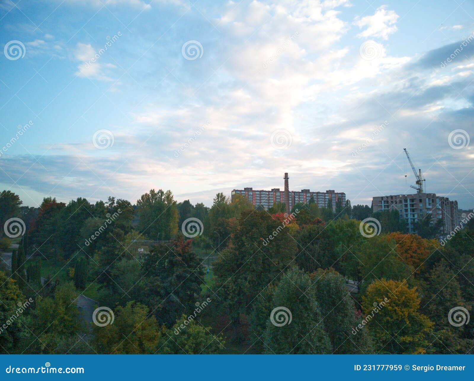 Lovely sunset in cozy city stock image. Image of cloud - 231777959