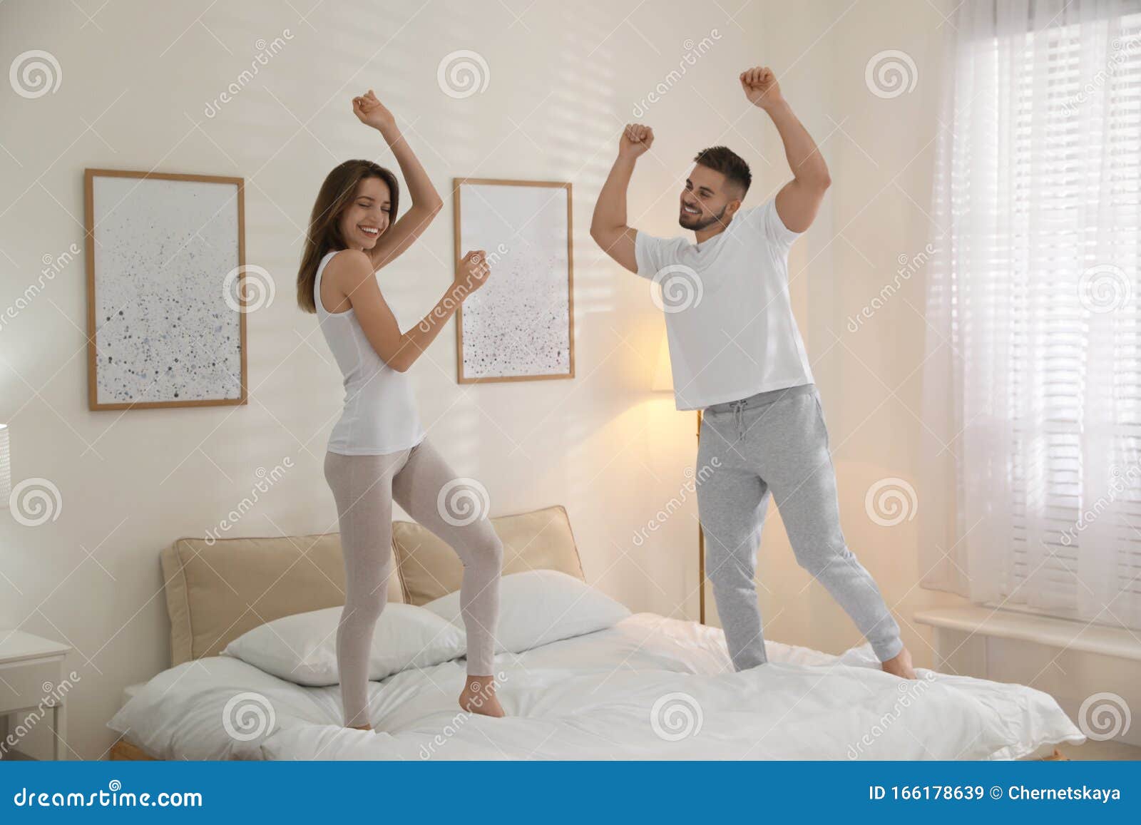 Lovely Young Couple Dancing on Bed Stock Image - Image of husband ...