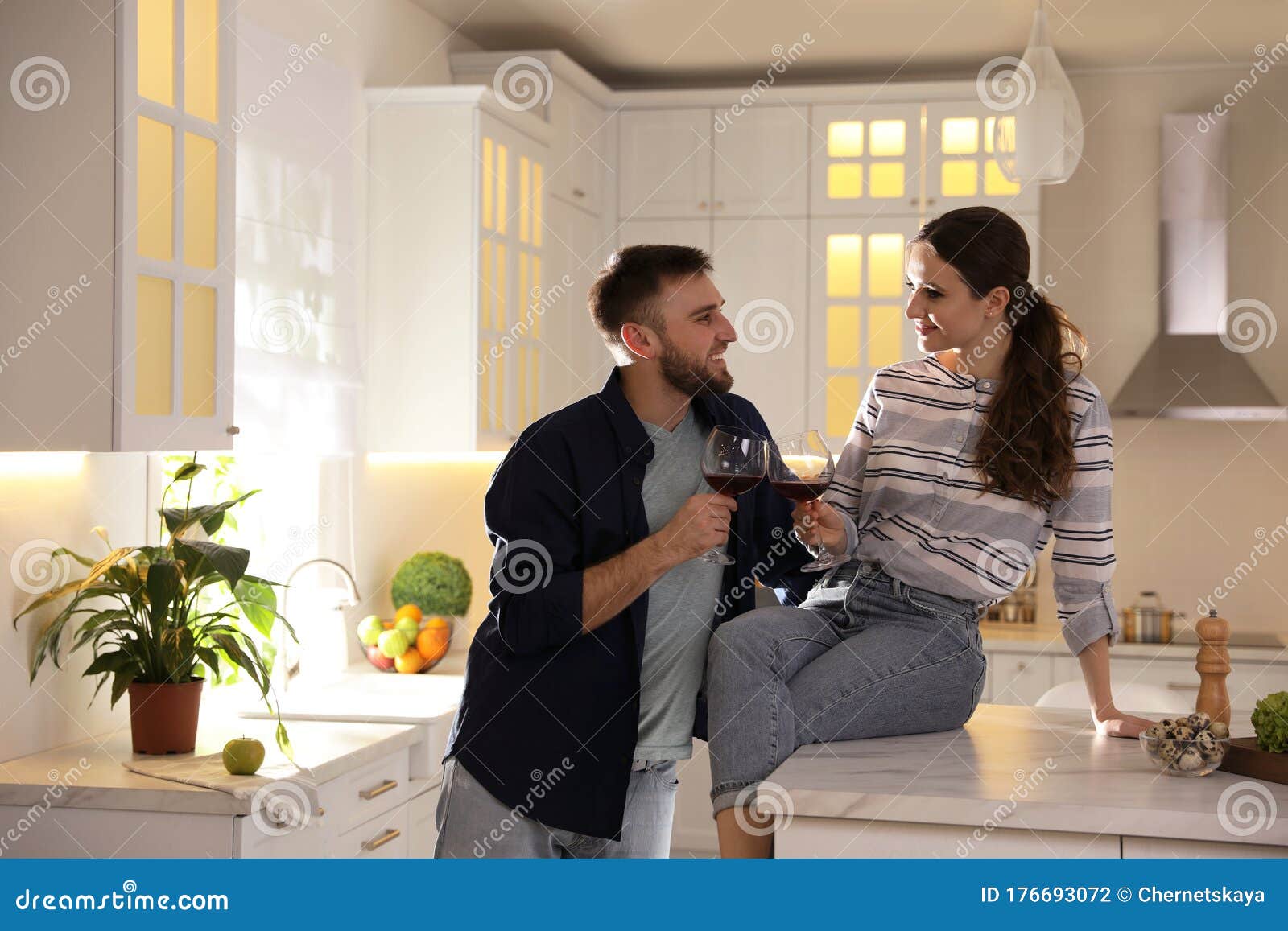 Lovely Young Couple Drinking Wine while Cooking in Kitchen Stock Photo ...