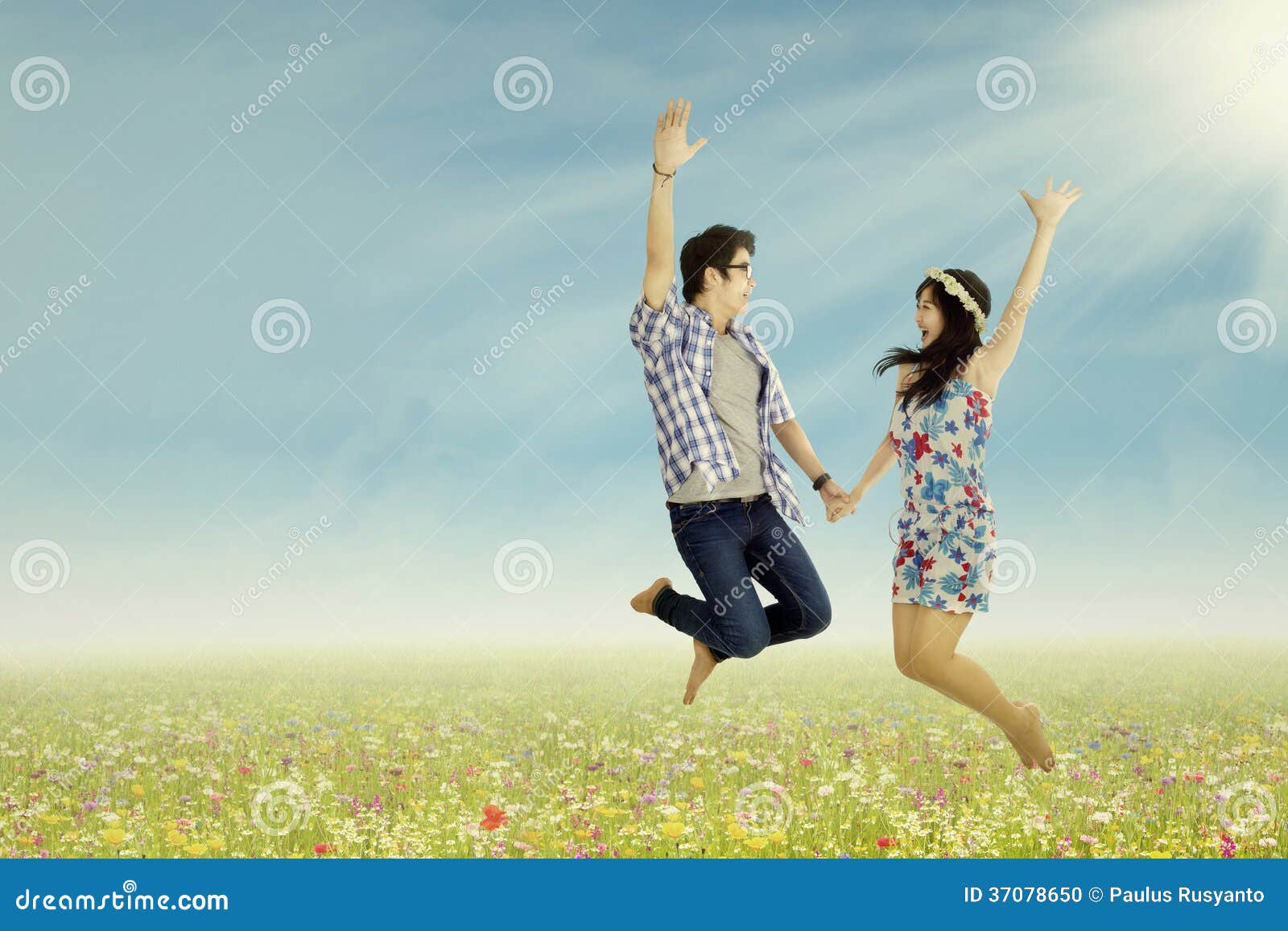 A Lovely Young Couple Jumping Stock Photo - Image of joyful, leisure ...