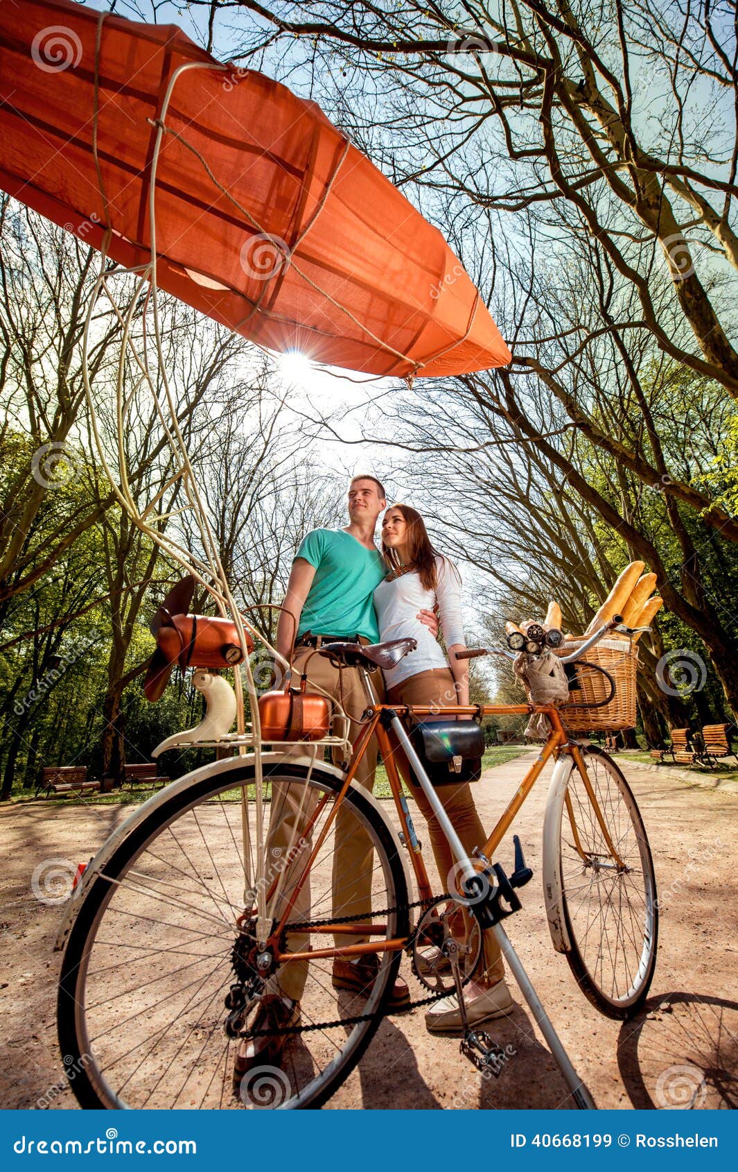 Lovely Young Couple Standing and Hugging Behind the Bicycle with Stock ...