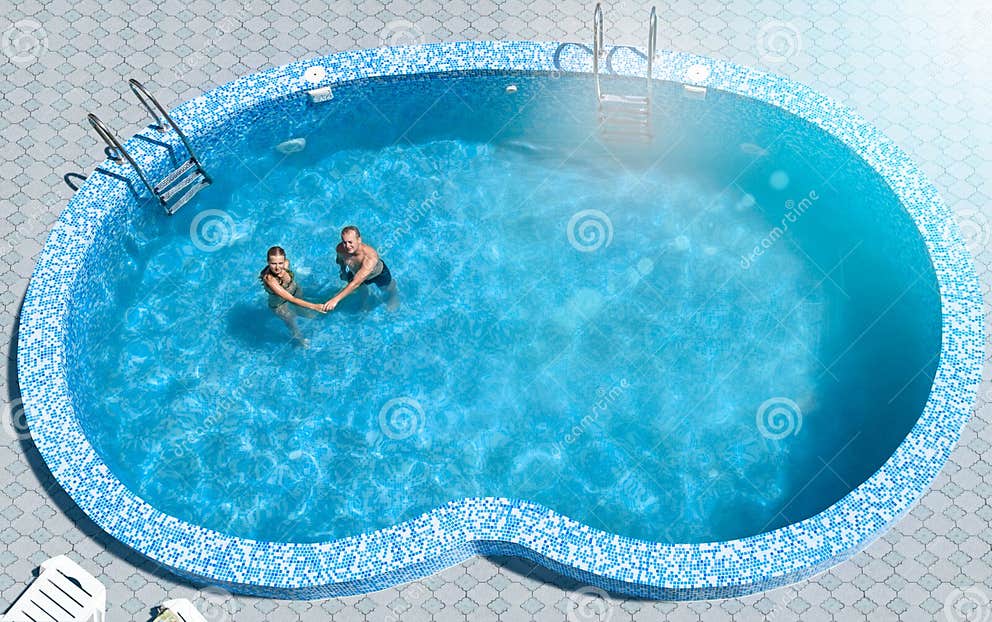 Lovers swim in the pool stock image. Image of sensuality - 28971329