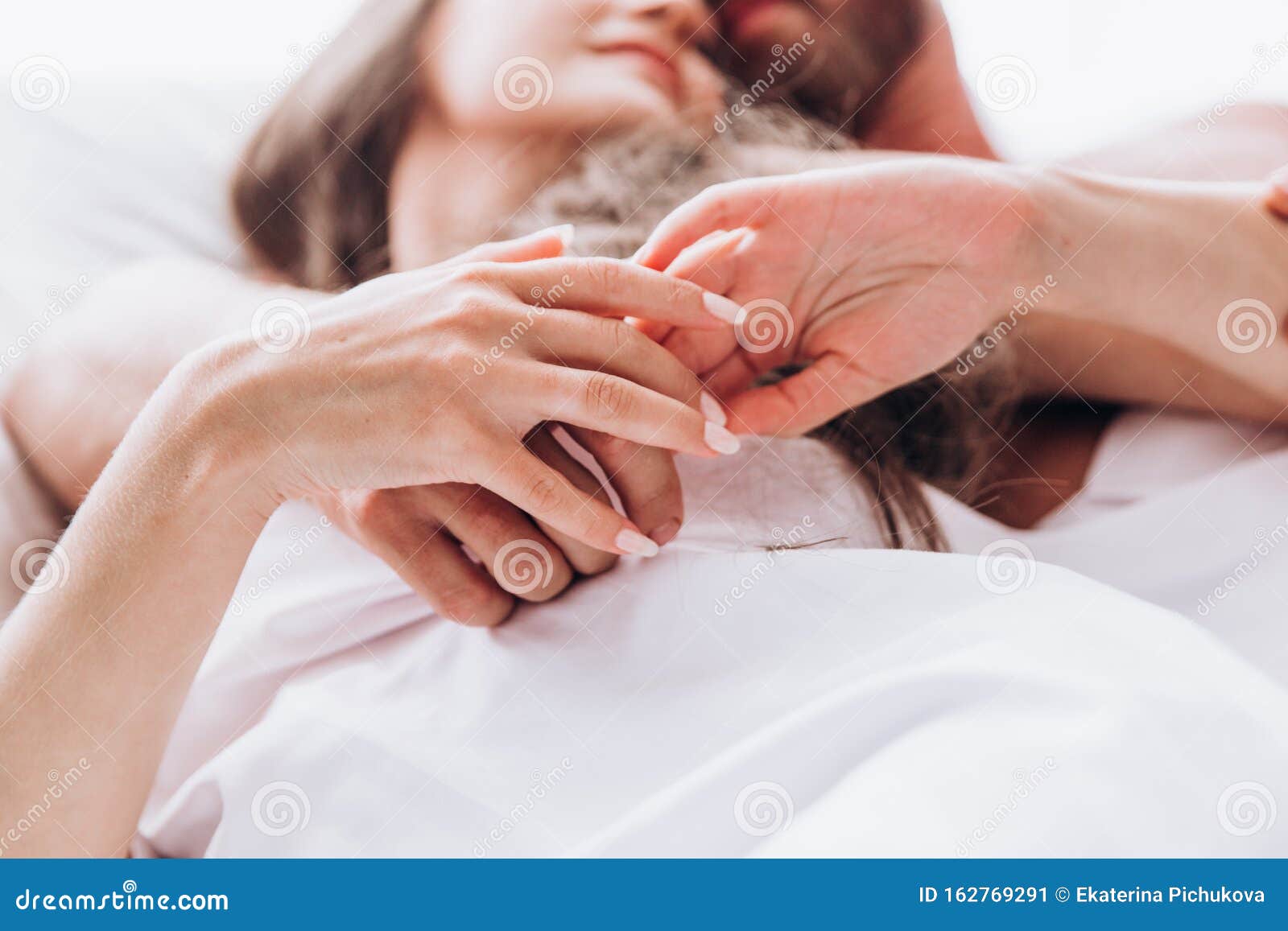 A Loving Couple Laughs in Bed. Smiling at Each Other on White Sheets ...