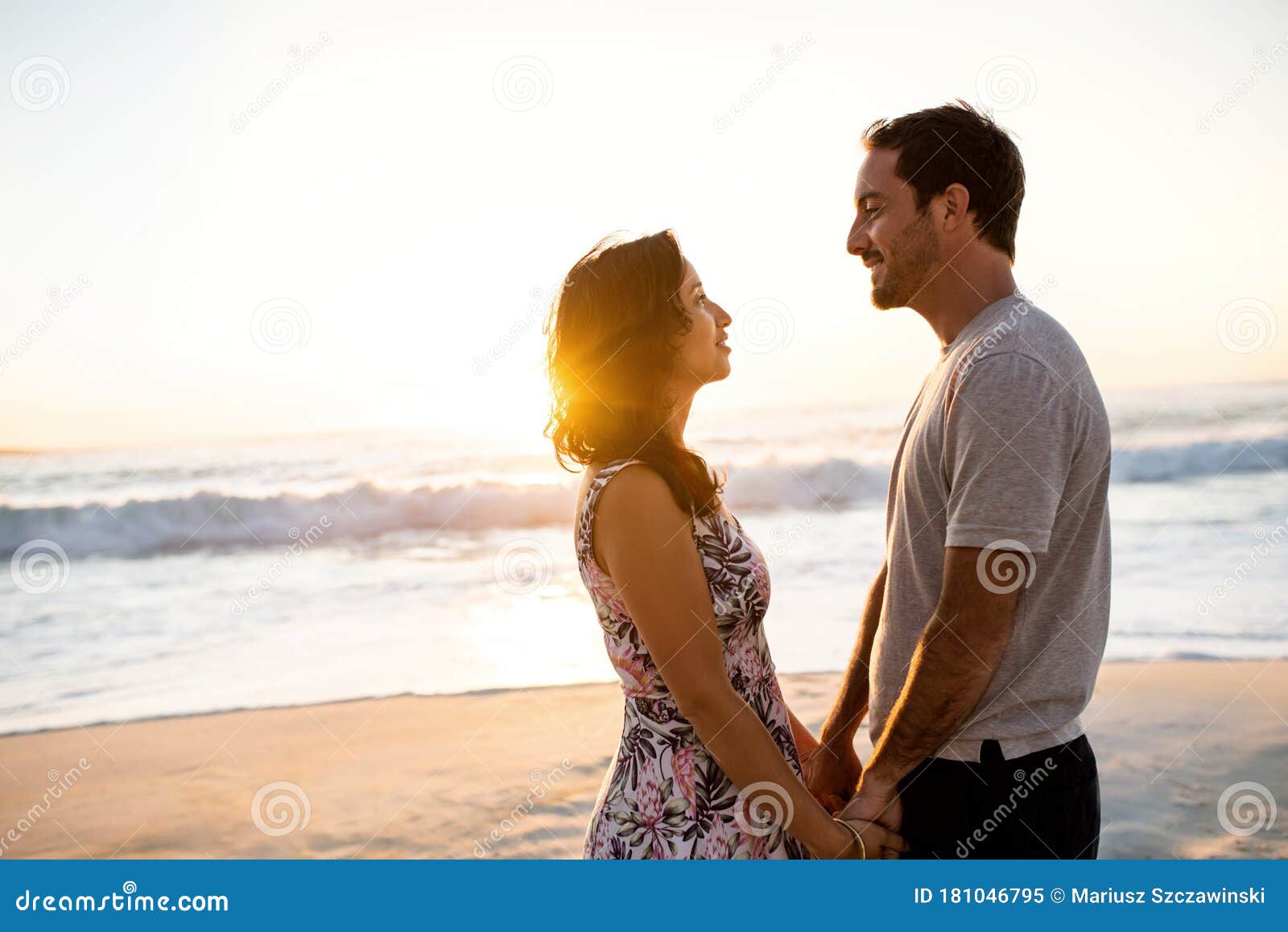 Loving Couple Looking Into Each Other`s Eyes On A Beach Stock Image