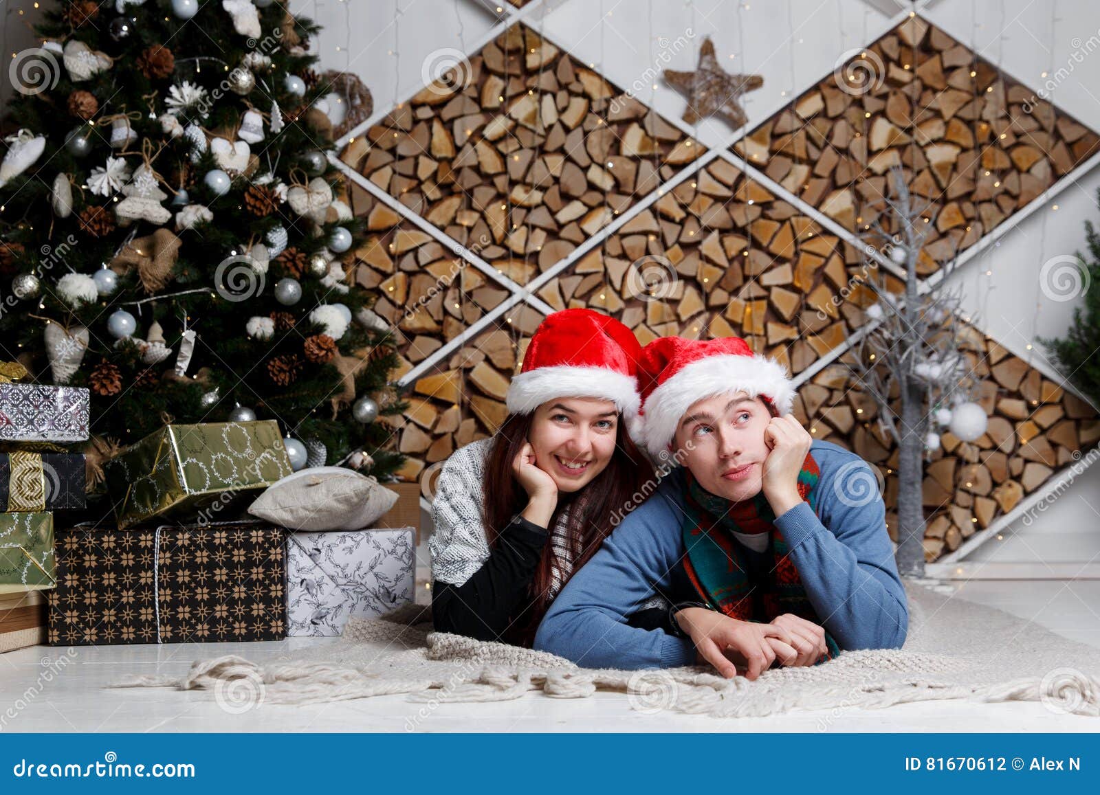 Loving couple lying on rug stock photo. Image of gift - 81670612