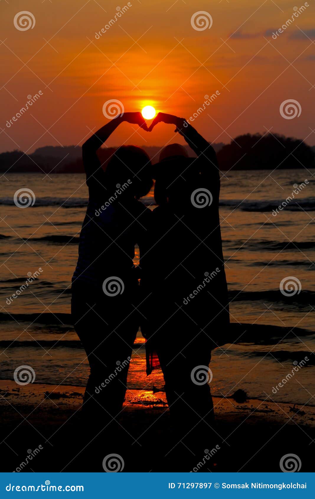 Loving Couple Make Heart Shape on Beach with the Sun Set Stock Image ...