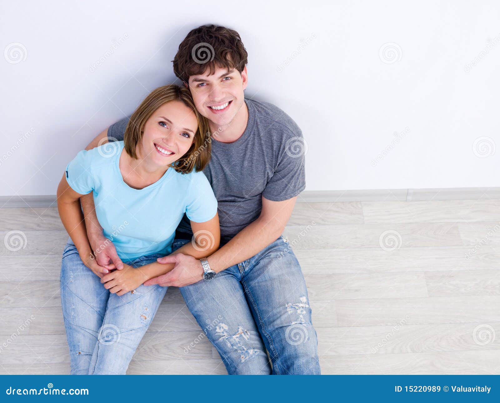 Loving Couple Sitting on the Floor in Embrace Stock Image - Image of ...