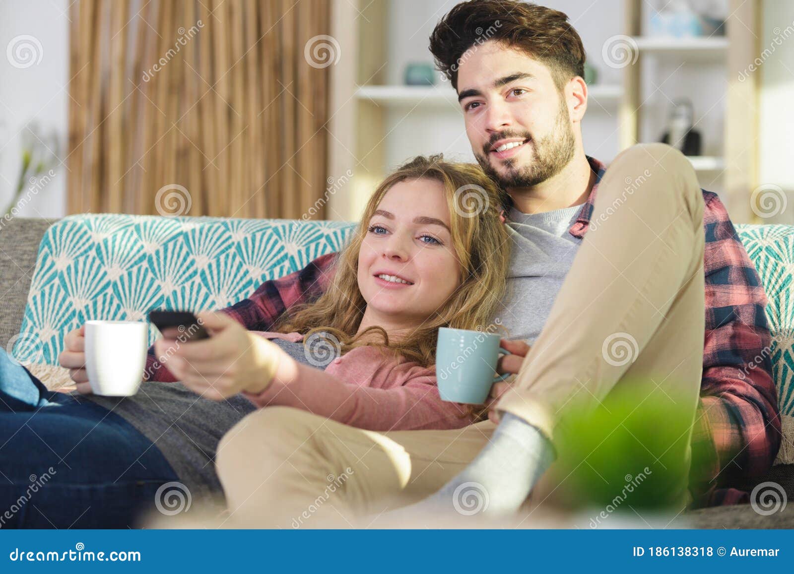 Loving Couple Snuggling on Sofa with Cup Tea Stock Photo - Image of ...