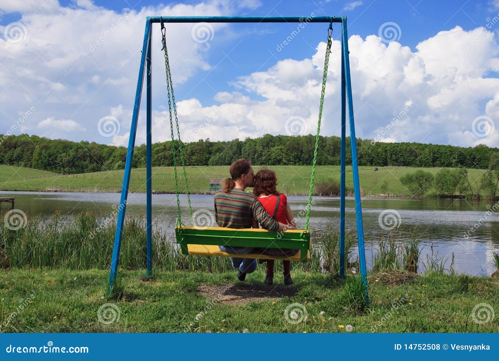 Loving couple on swings stock photo. Image of loving - 14752508
