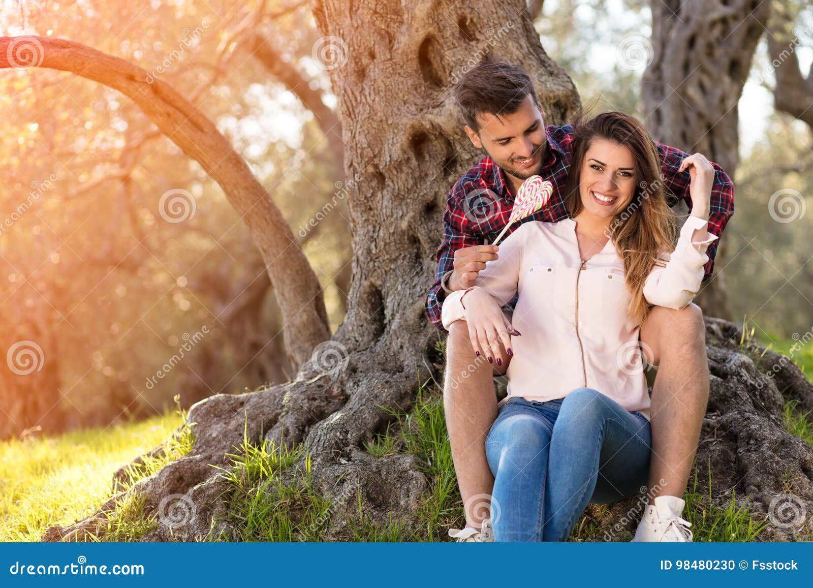 Loving Couple Under a Big Tree in the Park in Autumn Stock Photo ...