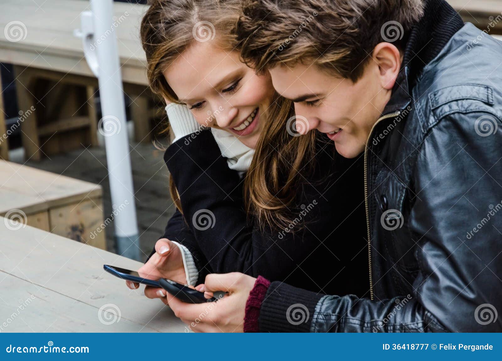 Loving Couple Using Mobile Phone at Bench Stock Image - Image of cell ...