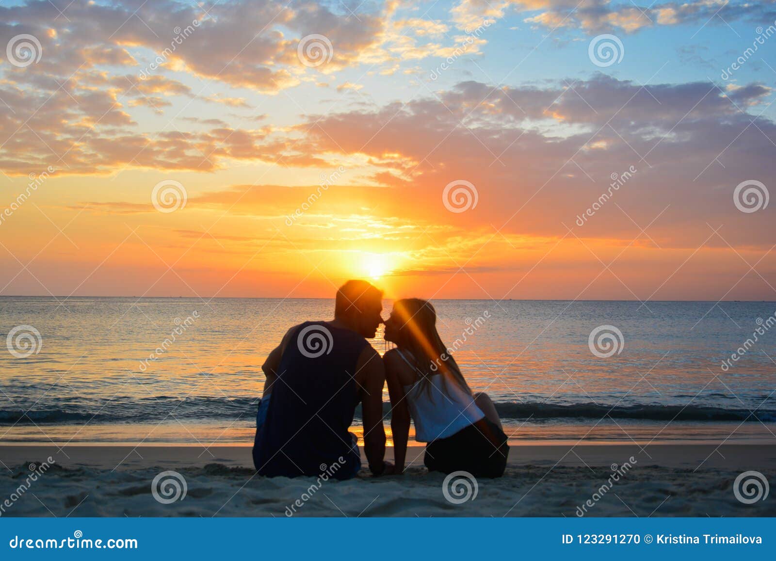 Couple Watching the Sunset on the Beach Stock Photo - Image of golden ...