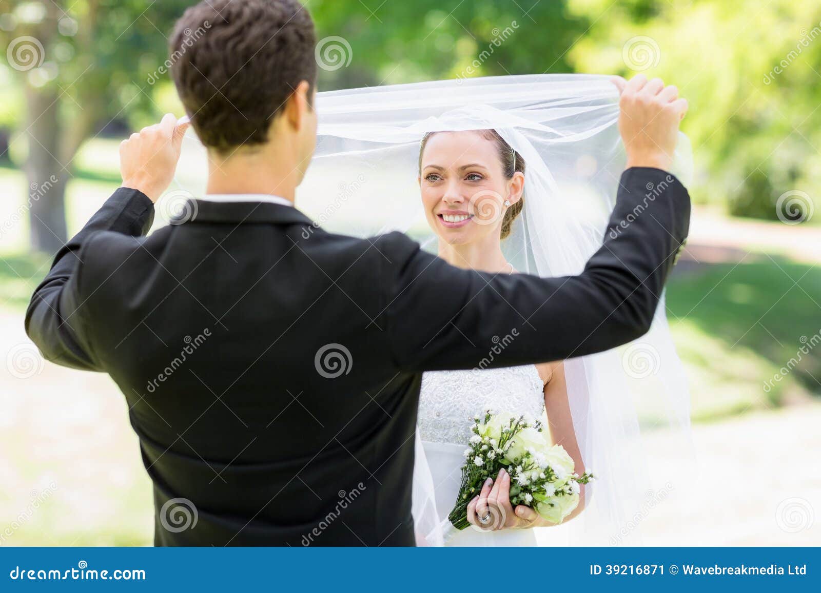 Loving Groom Lifting Veil of Bride Stock Image - Image of elegant ...