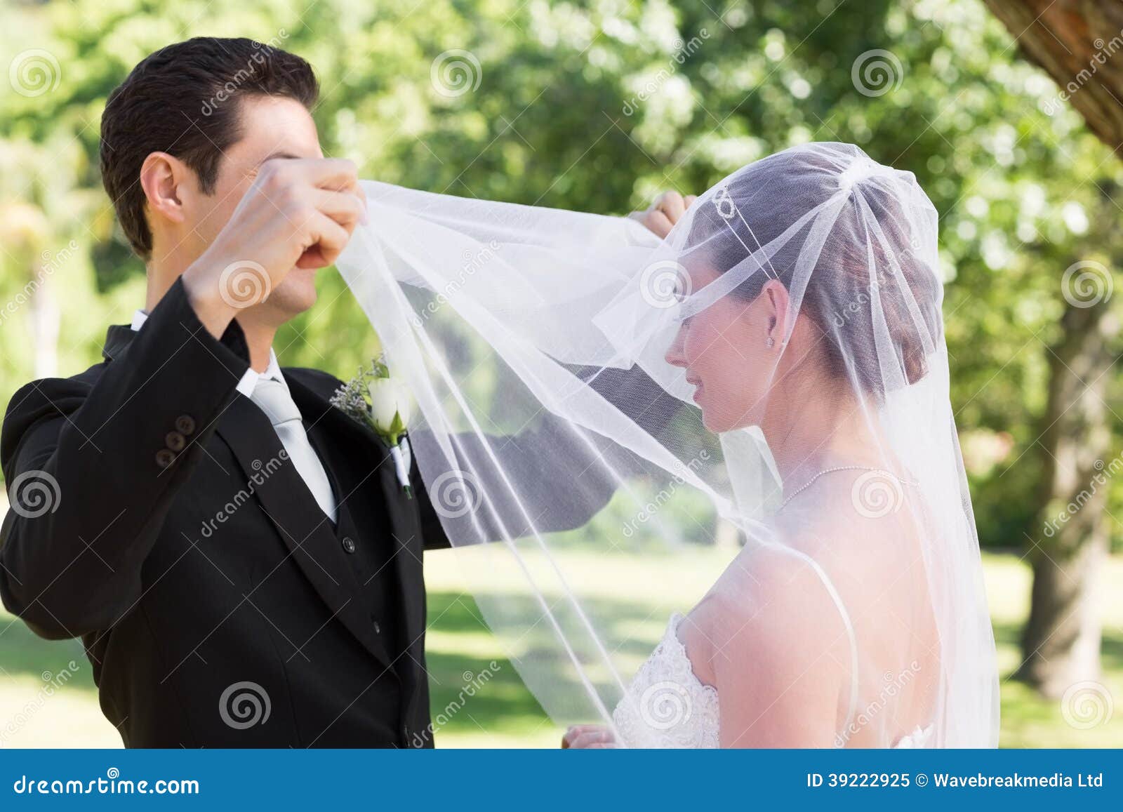 Loving Groom Unveiling Bride in Garden Stock Image - Image of focus ...