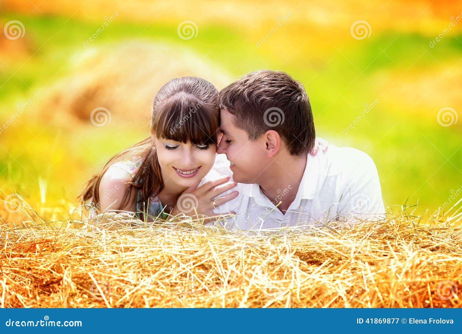 Loving Happy Couple Having Fun in a Field on a Haystack. Summer Stock ...