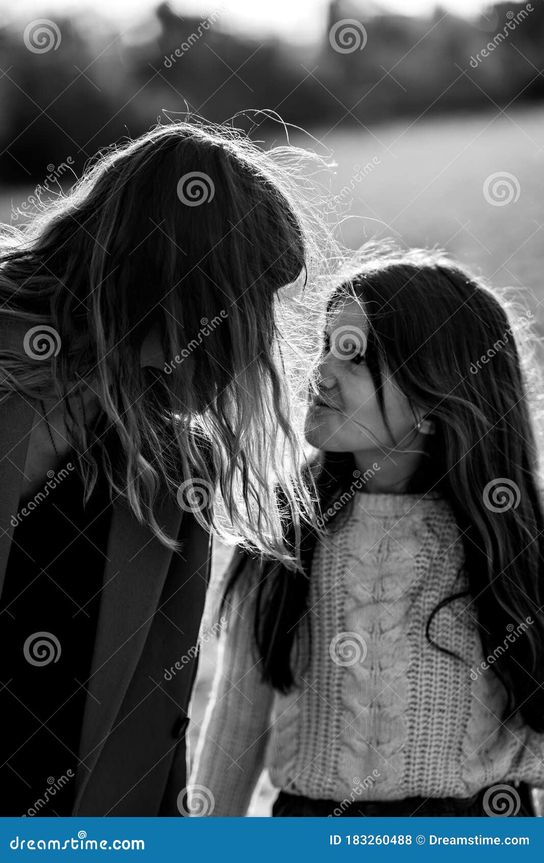 Loving Mother And Daughter Have Fun On The Beach At Sunset They Smile