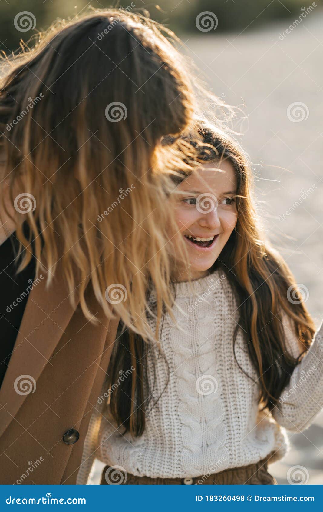 Loving Mother And Daughter Have Fun On The Beach At Sunset They Smile