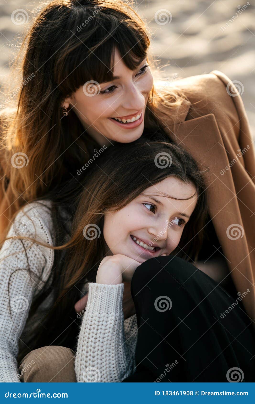 Loving Mother And Daughter Have Fun On The Beach At Sunset They Smile