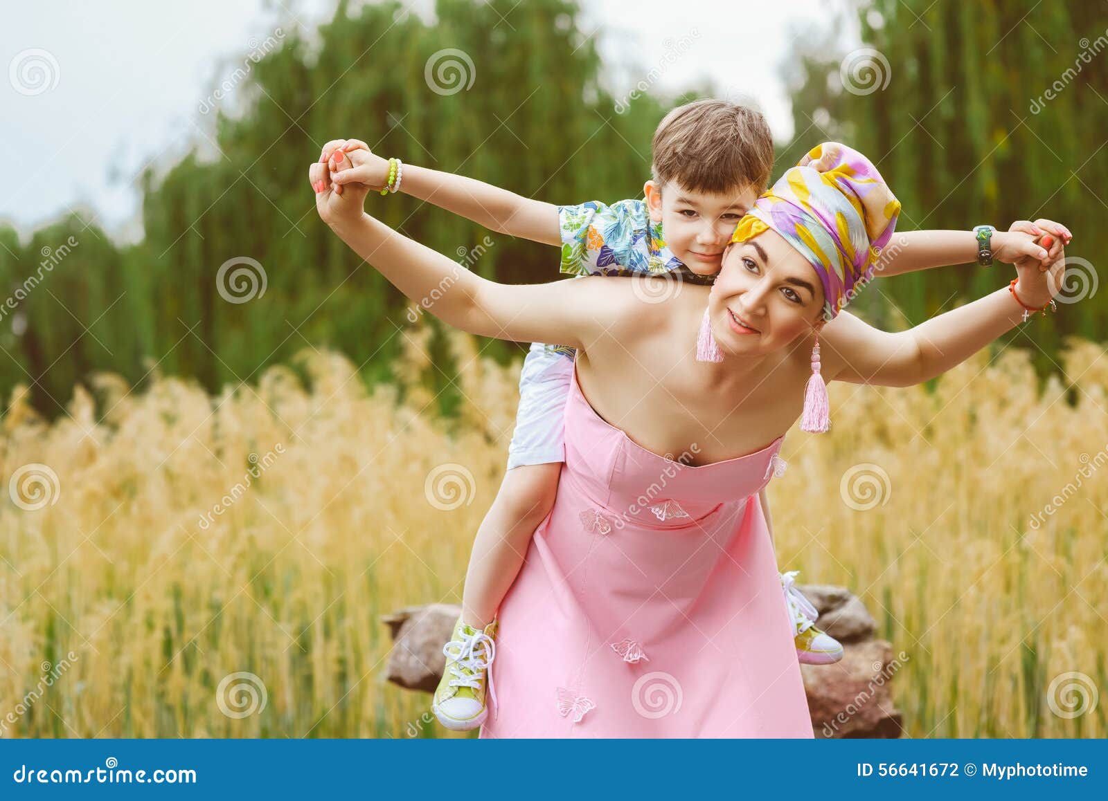 Loving Mother Rolls on a Back of Small Son Stock Photo - Image of ...