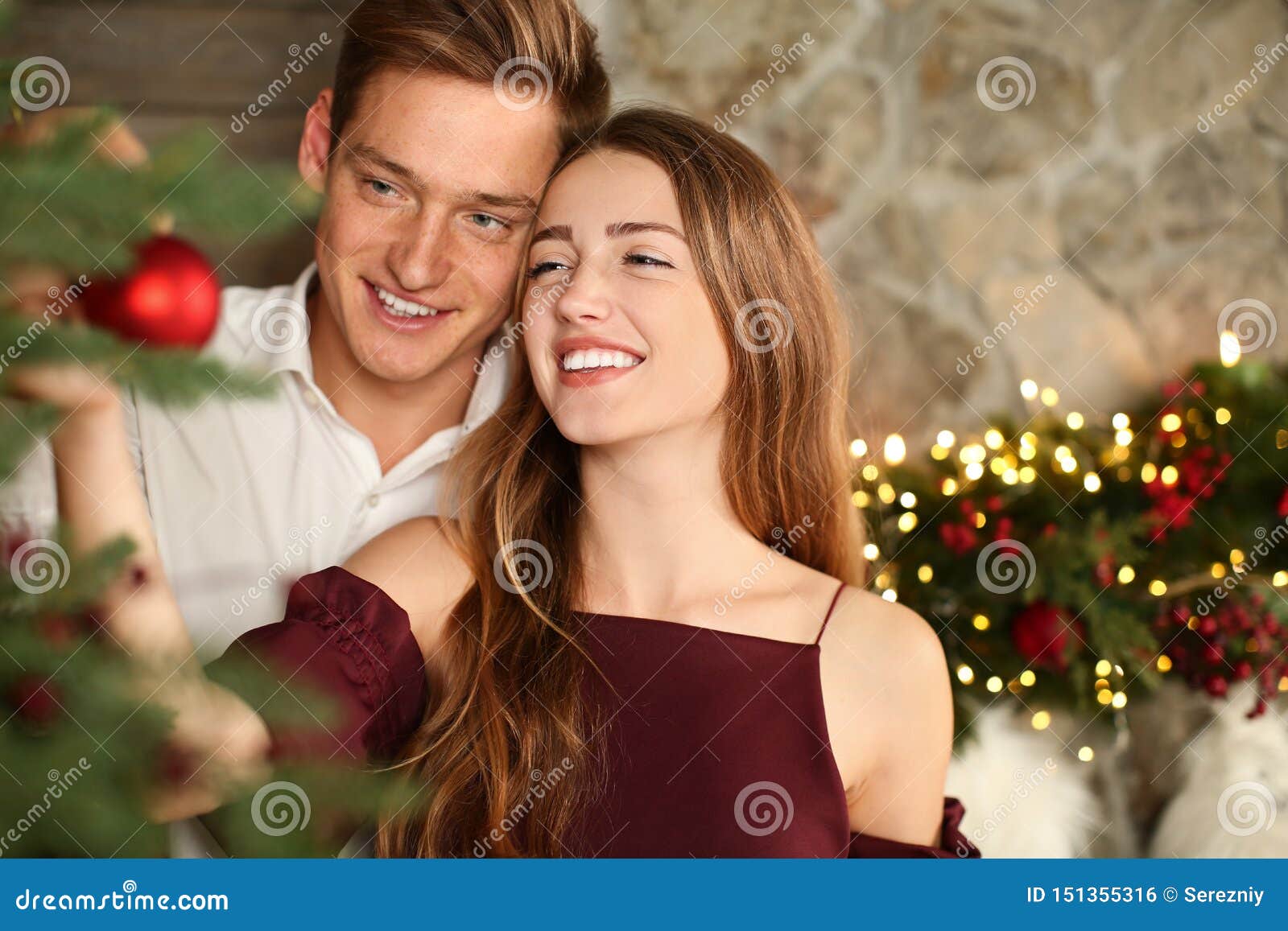 Loving Young Couple Decorating Christmas Tree at Home Stock Photo ...