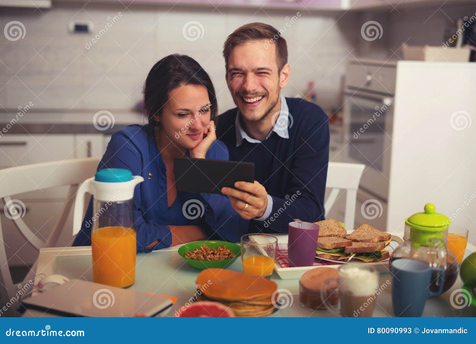 Loving Young Couple in Kitchen by Breakfast Table in Mor Stock Image ...
