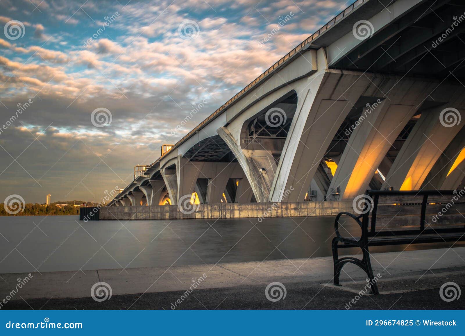 Low Angle of a Bridge Illuminated at Sunset Over a River Stock Image ...