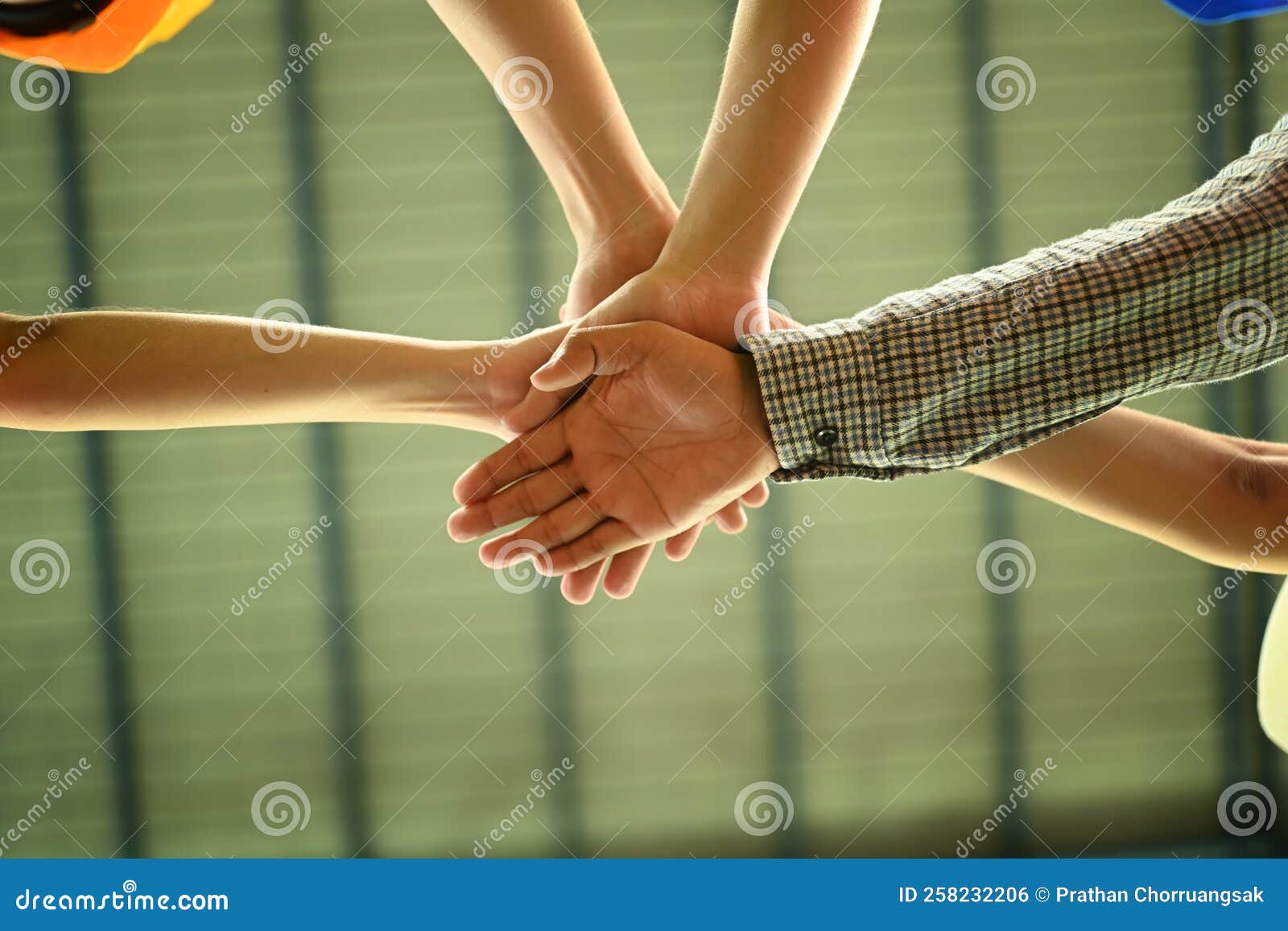 Low Angle Closeup Of Warehouse Worker Stacking Of Hands Showing The ...