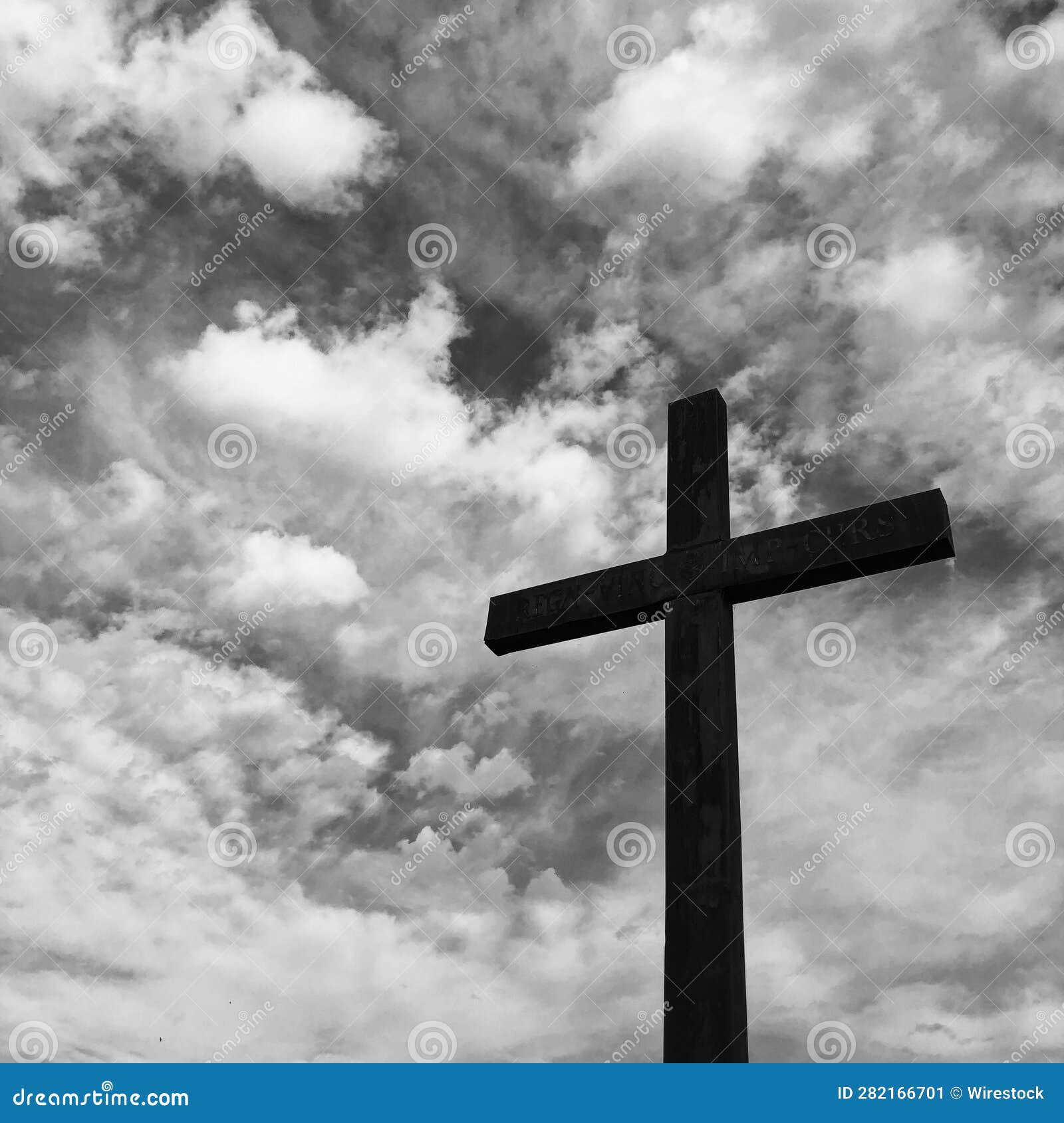 Low Angle of a Cross Against a Cloudy Sky in Grayscale Stock Image ...